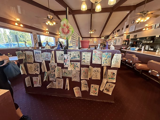 A gallery of children's artwork transforms this divider into a community museum &ndash; each crayon masterpiece telling stories of family meals shared.
