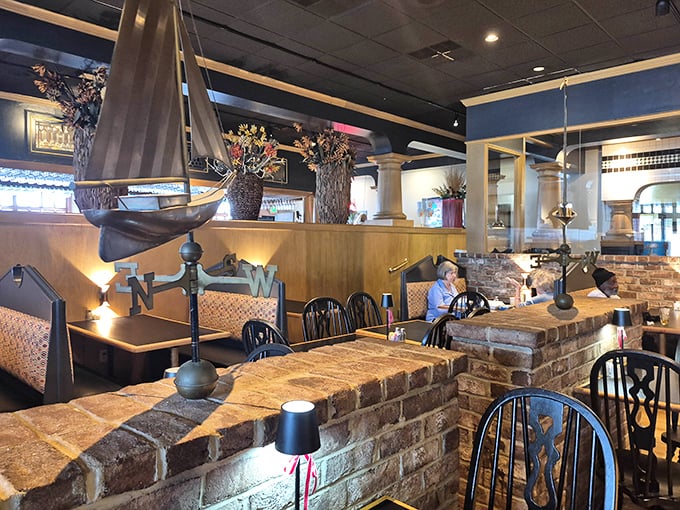 Brick dividers and warm lighting create intimate dining spaces where conversations flow as smoothly as the wine.