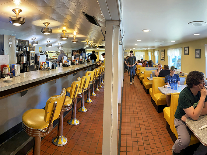 Classic diner perfection with those unmistakable yellow vinyl booths. Like sliding into a time machine where the coffee's always hot and calories don't count.