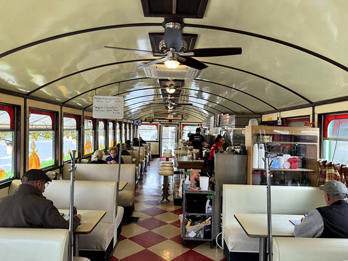 Sunlight streams through windows illuminating the diner's iconic barrel ceiling and checkerboard floor&mdash;American nostalgia served in its purest form.
