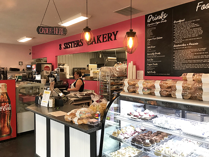 The vibrant pink walls aren't just Instagram-worthy; they're the perfect backdrop for serious pastry contemplation and coffee consumption.