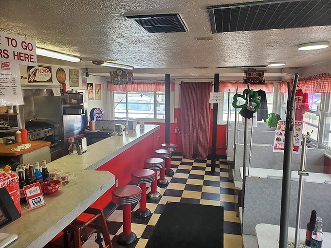The classic black-and-white checkered floor and red vinyl stools aren't retro by design&mdash;they're authentic by survival, a diner that never needed reinvention.