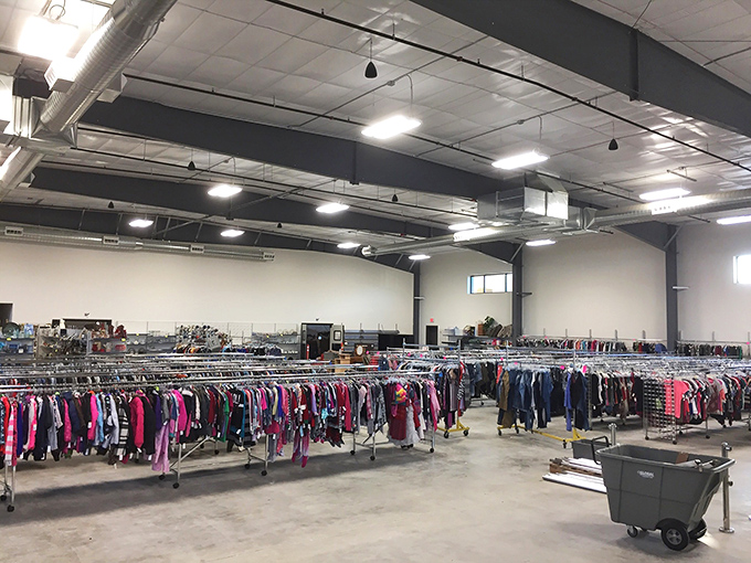 An ocean of clothing racks stretches to the horizon, each metal rail a lifeline to fashion possibilities and second chances.