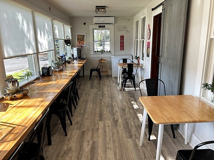 Sunlight streams across wooden countertops and minimalist seating, creating the perfect backdrop for morning conversations or peaceful solo coffee sessions.