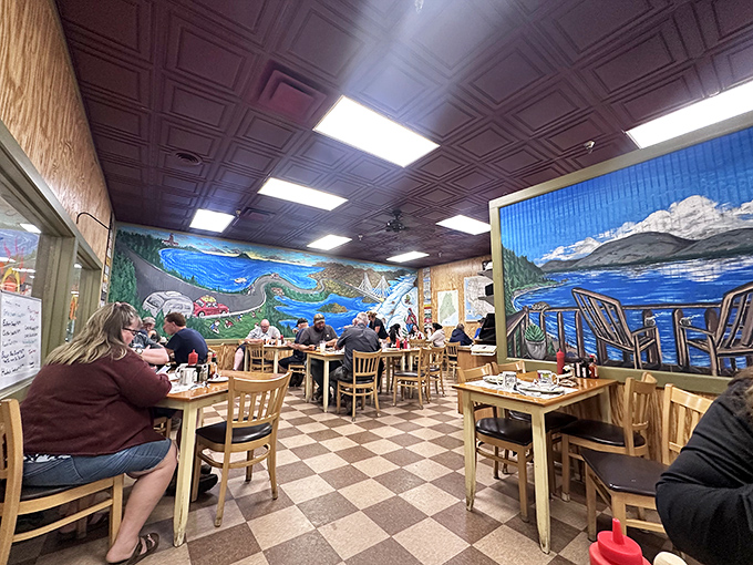Step inside and you're transported by stunning murals of Maine's coastal beauty. The checkered floor and wooden tables say "classic diner," but those painted landscapes? Pure Down East magic.