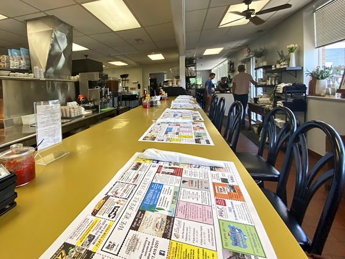The iconic yellow counter offers front-row seats to the kitchen action, where placemats double as local community bulletin boards.