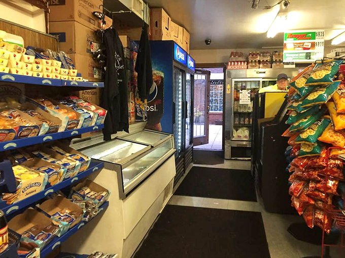 No frills, all thrills! The narrow corridor of snacks and coolers is your first clue that this place prioritizes sandwich-making over interior design.