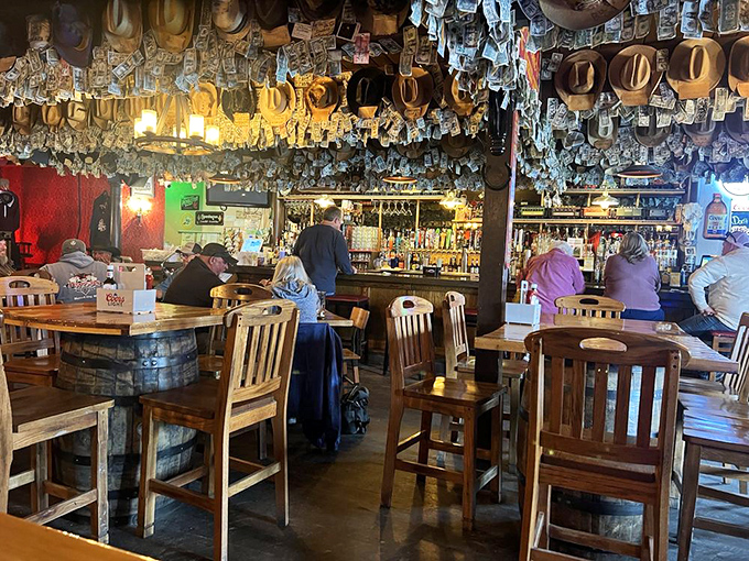 Dollar bills and cowboy hats suspended from the ceiling create a uniquely Western canopy above patrons enjoying drinks at the bar&mdash;money well spent on atmosphere.