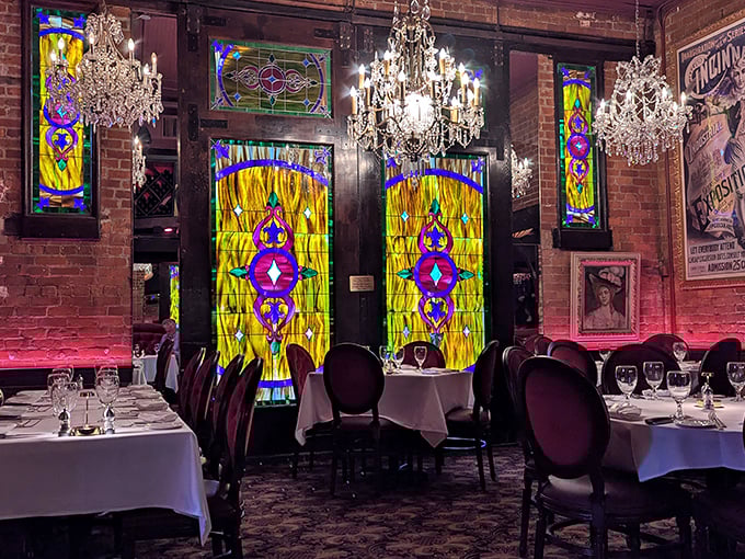 Crystal chandeliers dance above vibrant stained glass, creating a dining atmosphere that whispers "special occasion" even on a random Tuesday.