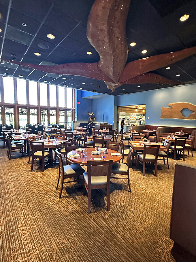 Beneath a striking octopus sculpture, diners enjoy the airy, blue-walled dining room where nautical elegance meets comfortable sophistication.