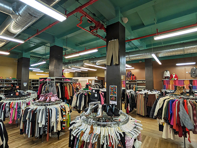 A fashion jungle where the turquoise ceiling and exposed pipes watch over circular racks that spin like vinyl records of style history.