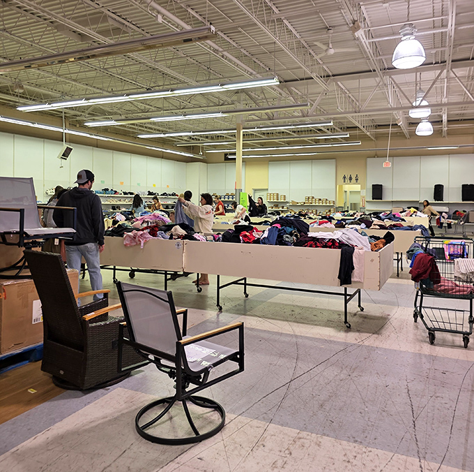 The main event: shoppers diving into bins with the focused determination of Olympic athletes. The thrill of the hunt is palpable in this retail wilderness.