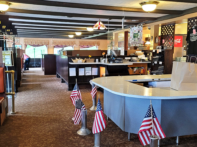 Small American flags stand guard at the counter where breakfast dreams come true. Democracy in action: everyone gets equal access to pancakes.