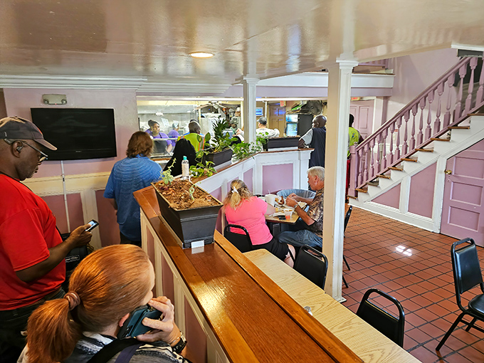 Inside, the pink walls and wooden counter create a homey atmosphere where strangers become friends united by the universal language of exceptional food.