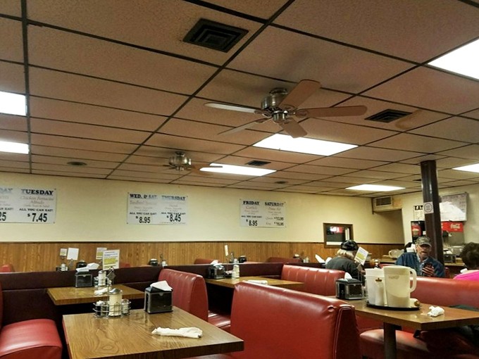 Classic diner ambiance with wood paneling and red vinyl booths&mdash;where conversations flow as freely as the coffee refills.