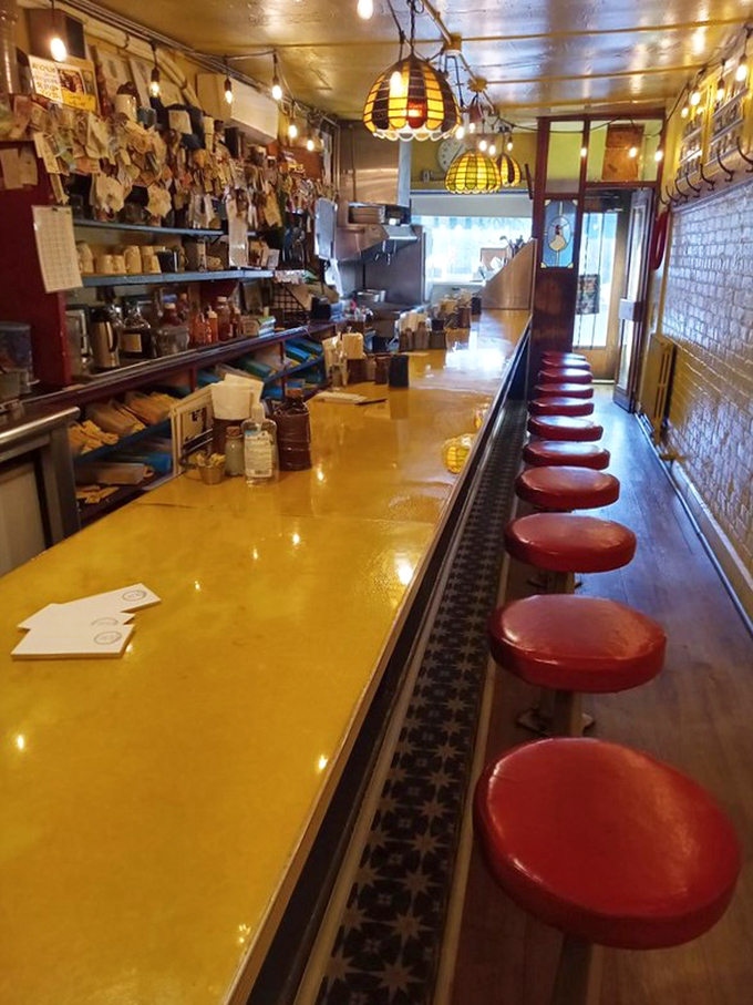 Fourteen red stools lined up like soldiers along that iconic yellow counter&mdash;this isn't just a diner, it's breakfast theater in the round.
