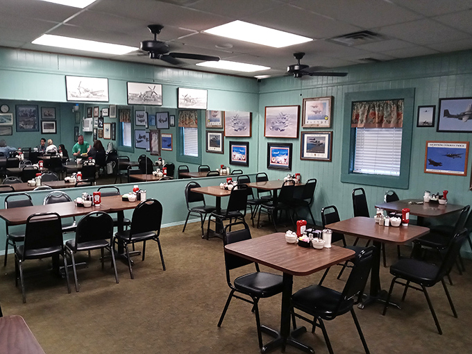 Classic diner vibes with turquoise walls and local artwork create the perfect comfort food atmosphere.