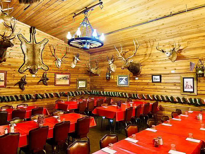 Log walls, hunting trophies, and red tablecloths create the perfect Western steakhouse atmosphere dreams are made of.