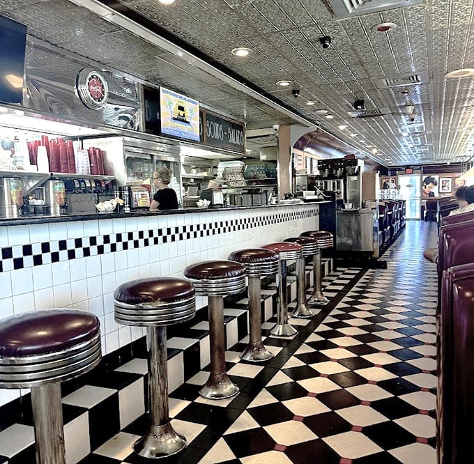 The quintessential American diner experience awaits at the counter, where those chrome stools have witnessed countless first dates and life-changing dessert decisions.
