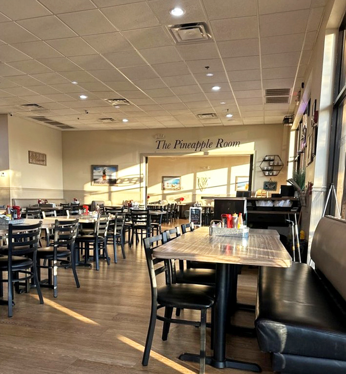 Welcome to "The Pineapple Room," where black chairs and wooden tables create the perfect stage for breakfast drama to unfold.