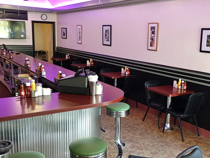 Classic diner aesthetics meet modern touches with purple accent lighting. It's where "Nighthawks" meets "Saturday Night Fever," and somehow it works perfectly.