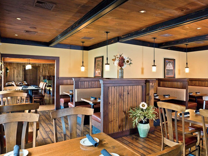 Rustic wooden beams meet cozy booth dividers inside Loxley's dining room. The warm interior feels like the great hall where Robin's merry band might gather.