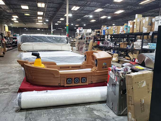 Somewhere between fantasy and furniture, a child's pirate ship bed sails through seas of mattresses and moving boxes.