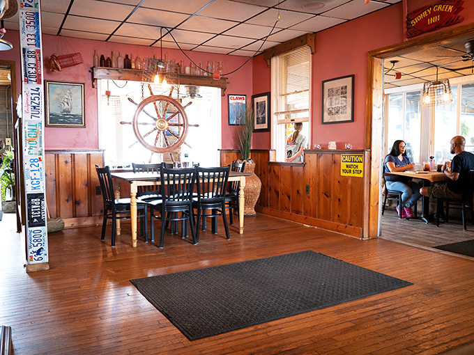 Nautical charm meets cozy comfort inside, with that ship's wheel saying "abandon diet, all ye who enter here!"