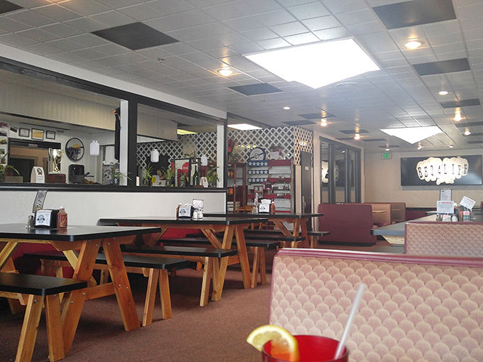 Picnic tables and cozy booths create that perfect backyard barbecue vibe without the hassle of cleaning your actual backyard.