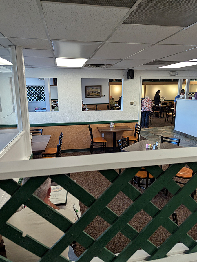 Those classic green lattice dividers aren't just decor&mdash;they're time machines to when conversations flowed between tables and coffee never went cold.