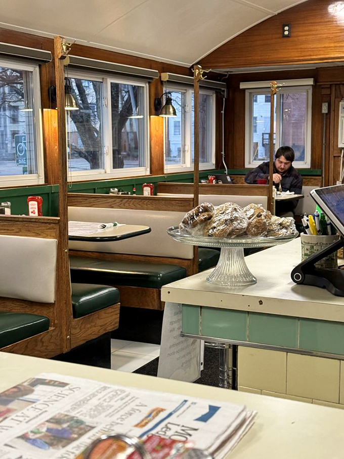 Classic diner booths where strangers become friends over coffee, while fresh-baked goods tempt you from their glass pedestal.