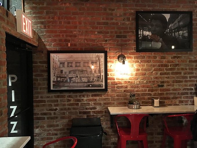 Exposed brick, vintage photos, and those signature red chairs&mdash;this isn't just d&eacute;cor, it's a love letter to old-school New York with modern pizza sensibilities.