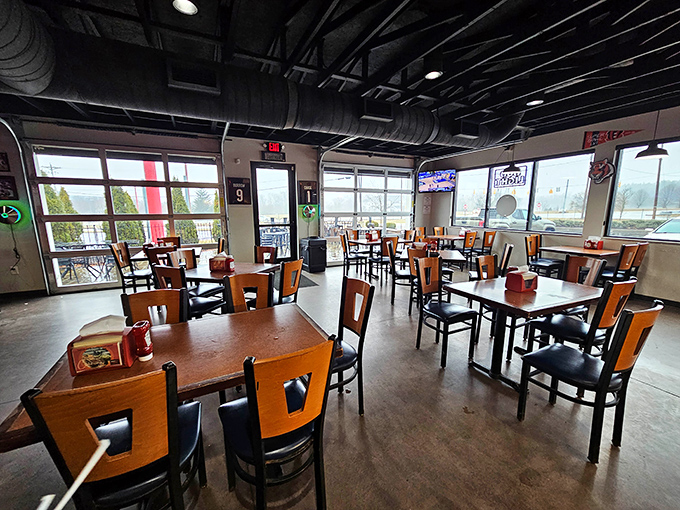 Industrial-chic meets comfort in this no-nonsense dining room. The exposed ductwork whispers, "We spent our money on the meat, not the ceiling." 