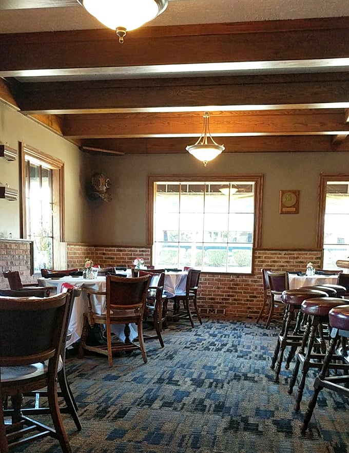 Exposed brick walls meet wooden beams in this dining room where time slows down, white tablecloths signaling you're somewhere special without any pretentious fuss.