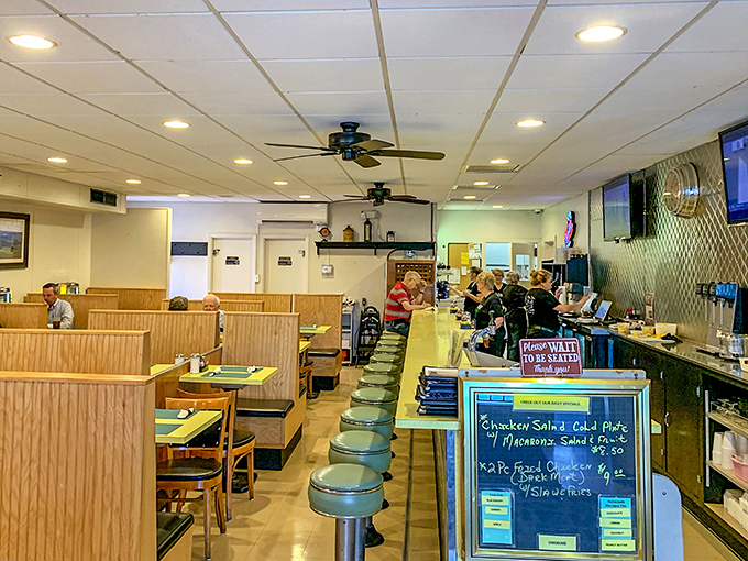 Mint-green counter stools and cozy wooden booths create the perfect backdrop for comfort food conversations. Time stands deliciously still here.