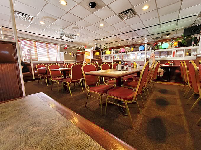 Classic red vinyl chairs and wood-paneled walls create the perfect backdrop for comfort food conversations and neighborhood gossip.