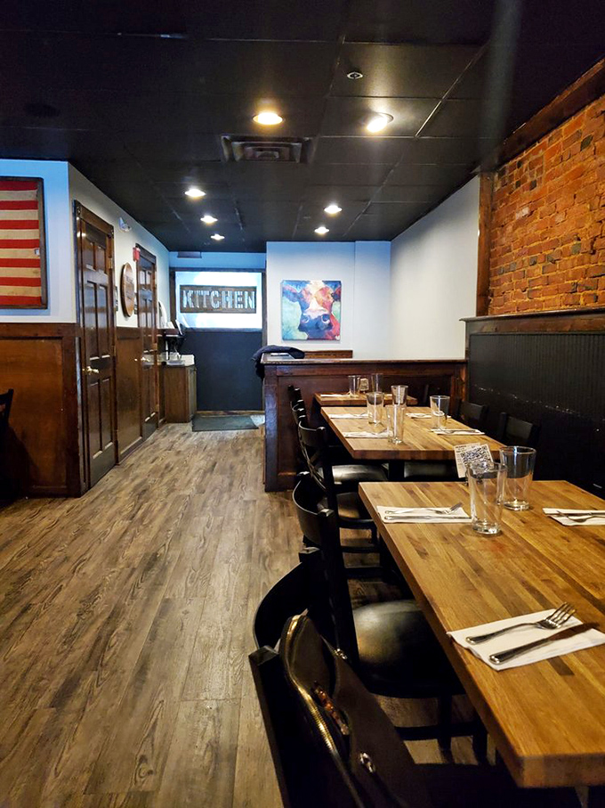 Rustic wooden tables, exposed brick, and that colorful cow painting&mdash;comfort meets cool in this intimate dining space.