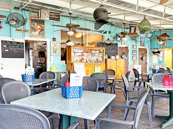 Nautical nostalgia meets practical comfort in this dining room where ceiling fans spin stories of fishermen past.