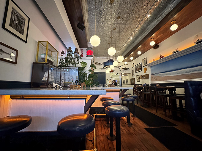 Step into a New England daydream: pressed tin ceilings, warm wood tones, and globe pendant lights create the perfect backdrop for seafood indulgence.