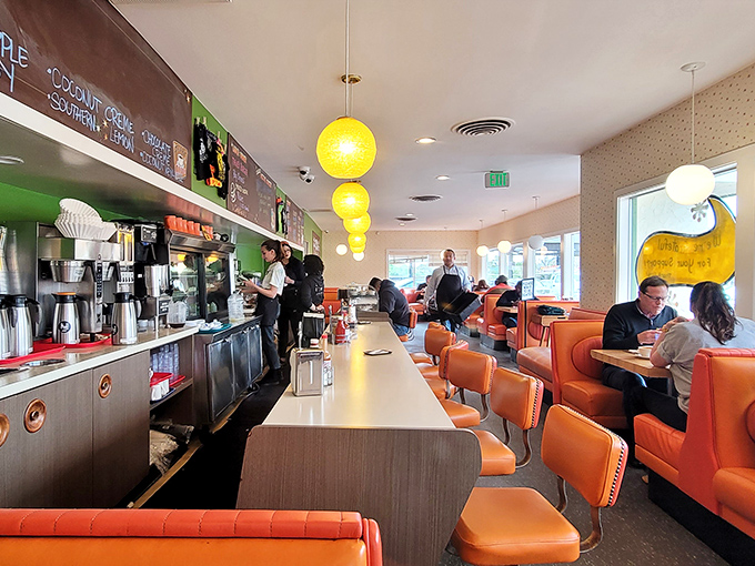 Inside, those orange vinyl booths aren't trying to be retro&mdash;they simply never left. Yellow pendant lights cast a glow that makes everyone look like they just returned from vacation.