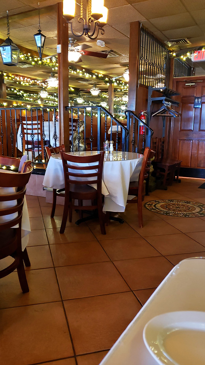 Twinkling lights create a magical canopy overhead, turning an ordinary Tuesday dinner into what feels like a celebration in Tuscany.