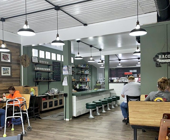 Inside, the perfect balance of cozy and functional awaits &ndash; green walls, wooden accents, and counter seating that's witnessed countless "first bite" moments of pure joy.