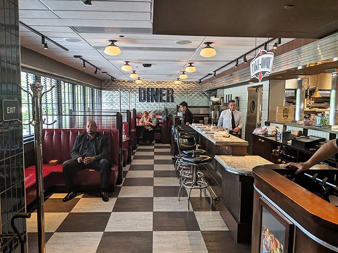 Classic black and white checkered floors meet red vinyl booths – this isn't your grandparents' diner unless your grandparents were impossibly cool.