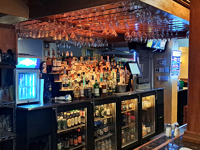 Glasses hanging like delicious chandeliers above a well-stocked bar. This isn't just drink storage&mdash;it's a sparkling preview of good times ahead.