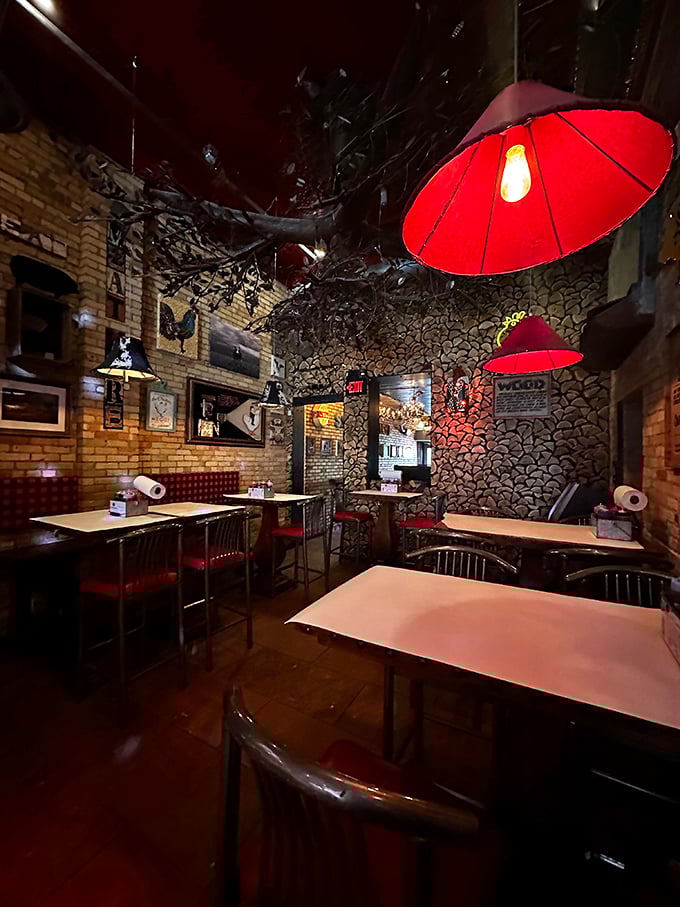 Red pendant lights cast a warm glow over the rustic interior, where wood-patterned walls remind you that serious smoking business happens here. Ambiance with attitude.
