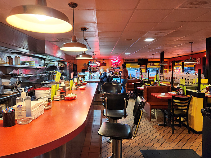 The classic counter seating offers front-row tickets to the breakfast ballet performed by skilled short-order cooks.