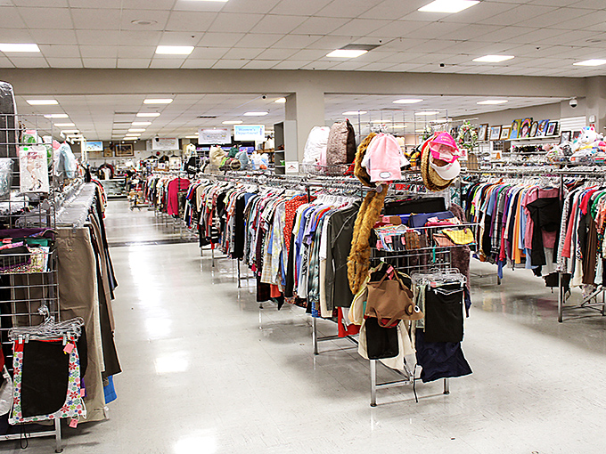 Rows upon rows of carefully organized clothing create a textile galaxy to explore. Each rack potentially harbors that designer piece someone mistakenly donated after spring cleaning.
