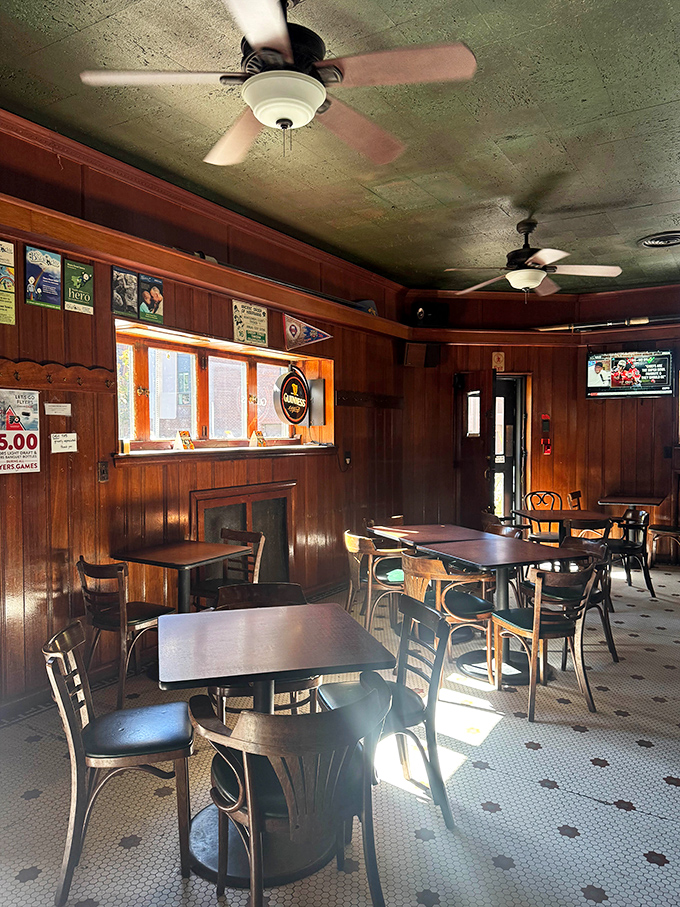 Wood-paneled walls, classic ceiling fans, and well-worn tables create the kind of genuine tavern atmosphere that no corporate restaurant designer could ever authentically replicate.