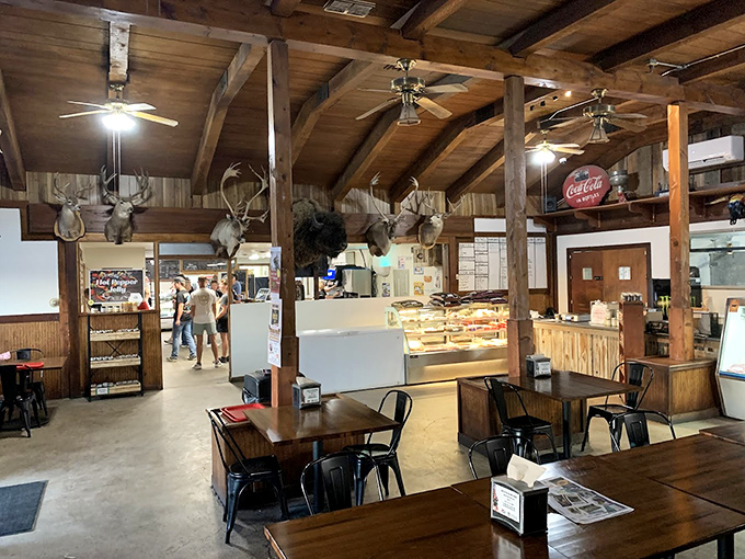 Wood beams, mounted trophies, and Coca-Cola nostalgia create the perfect atmosphere for destroying a pastrami burger without judgment.