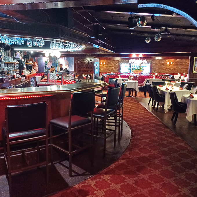 Step into a time capsule of red leather, warm lighting, and old-school charm. This isn't retro by design&mdash;it's authentic by persistence.